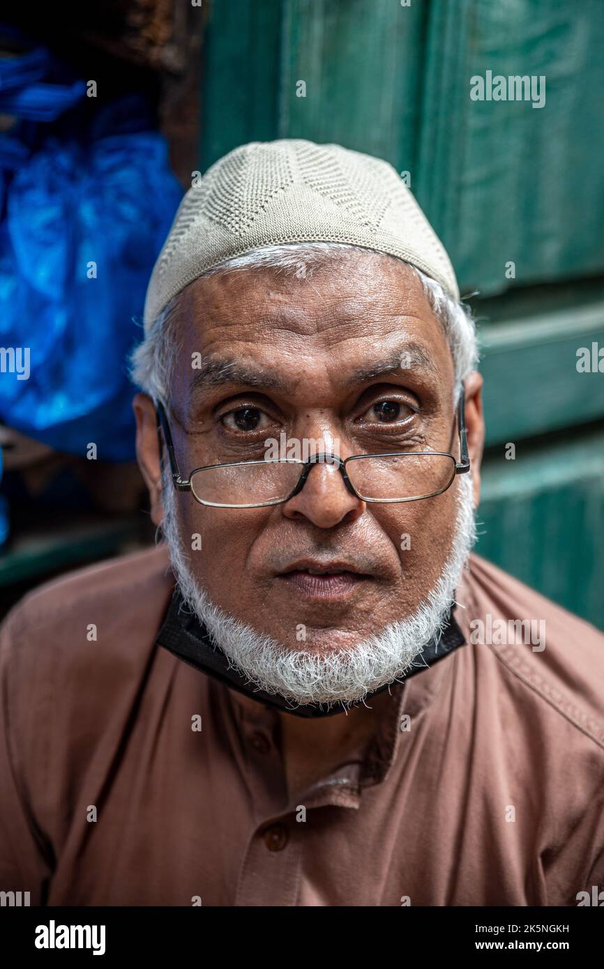 Close-up portrait of a pakistan adult man with glasses and white beard ...