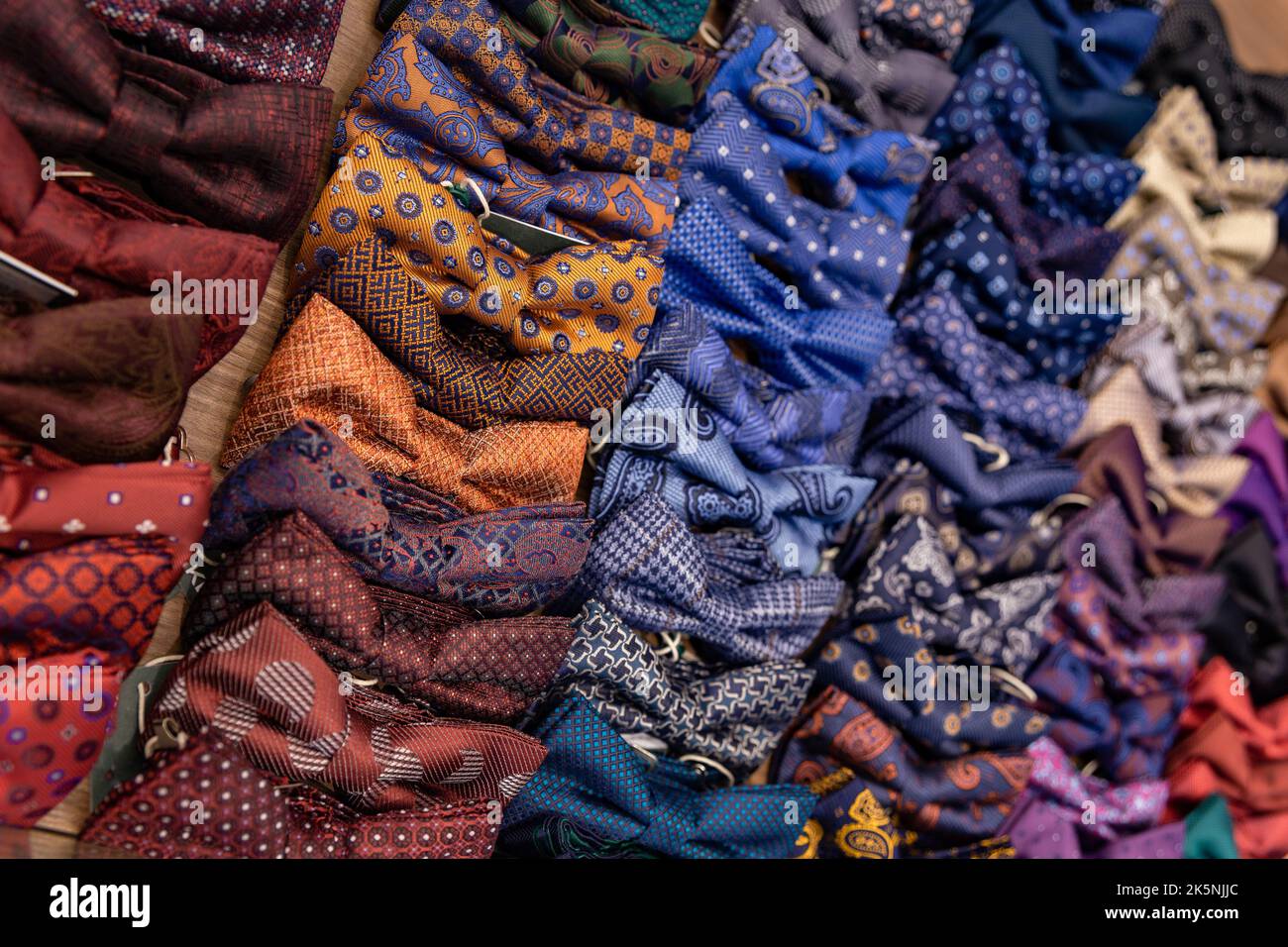 Showcase in a store with beautiful multi-colored bow ties. Many bright ...
