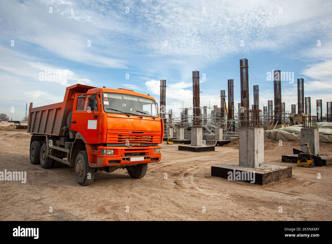An orange heavy-duty truck on the industrial construction Stock Photo ...
