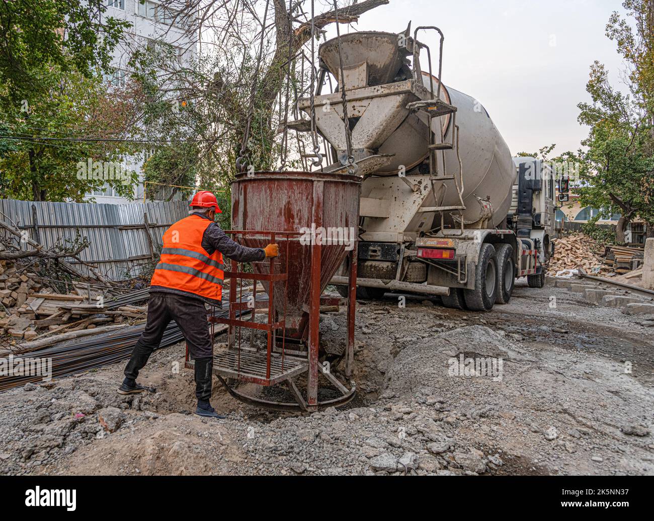 A man working on the concrete pouring bucket in the industrial ...