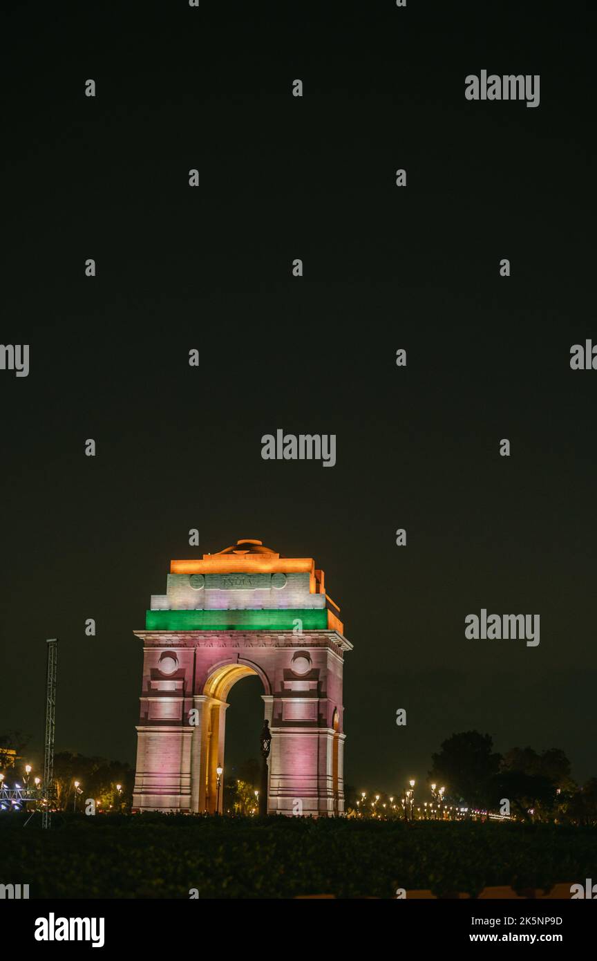 A vertical shot of the India Gate at Night (Kingsway) illuminated at ...