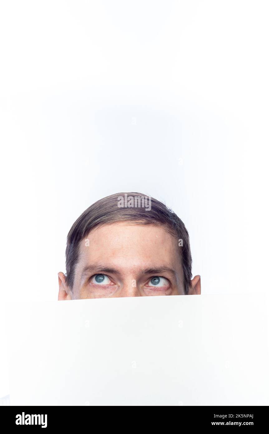 The person's face is covered with a white piece of paper, on an ...