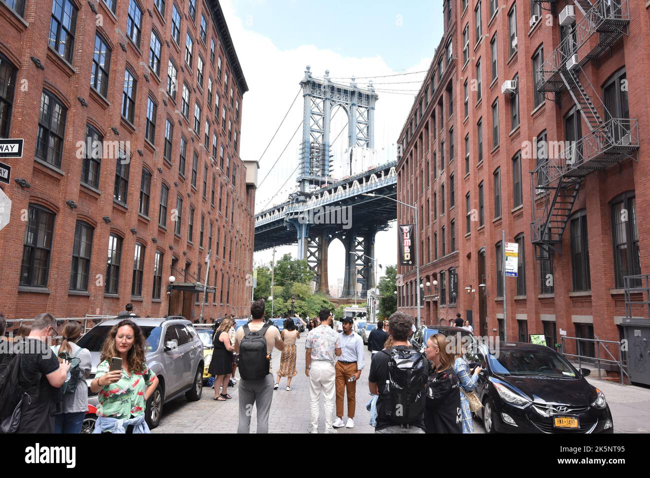 A beautiful white bridge with red buildings on both sides and people ...