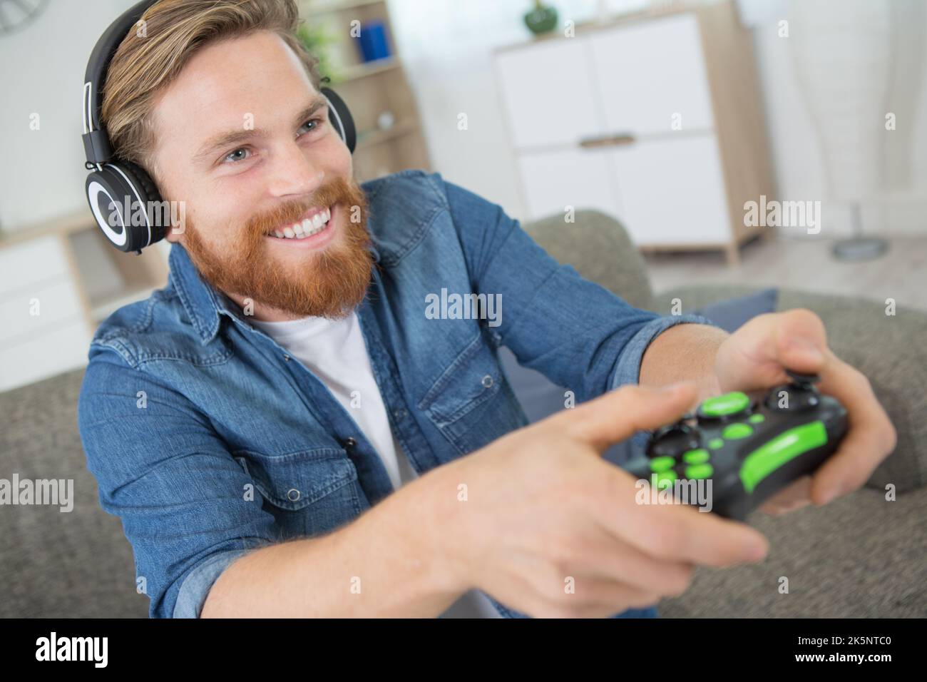 man holding a joystick controller while playing a video games Stock ...