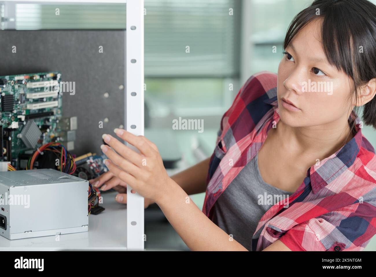 happy young woman trying to fix a pc Stock Photo - Alamy