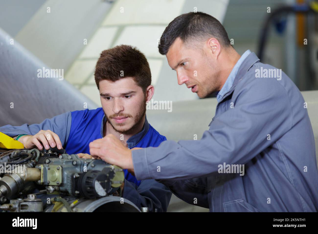 apprentice and teacher in hangar Stock Photo - Alamy