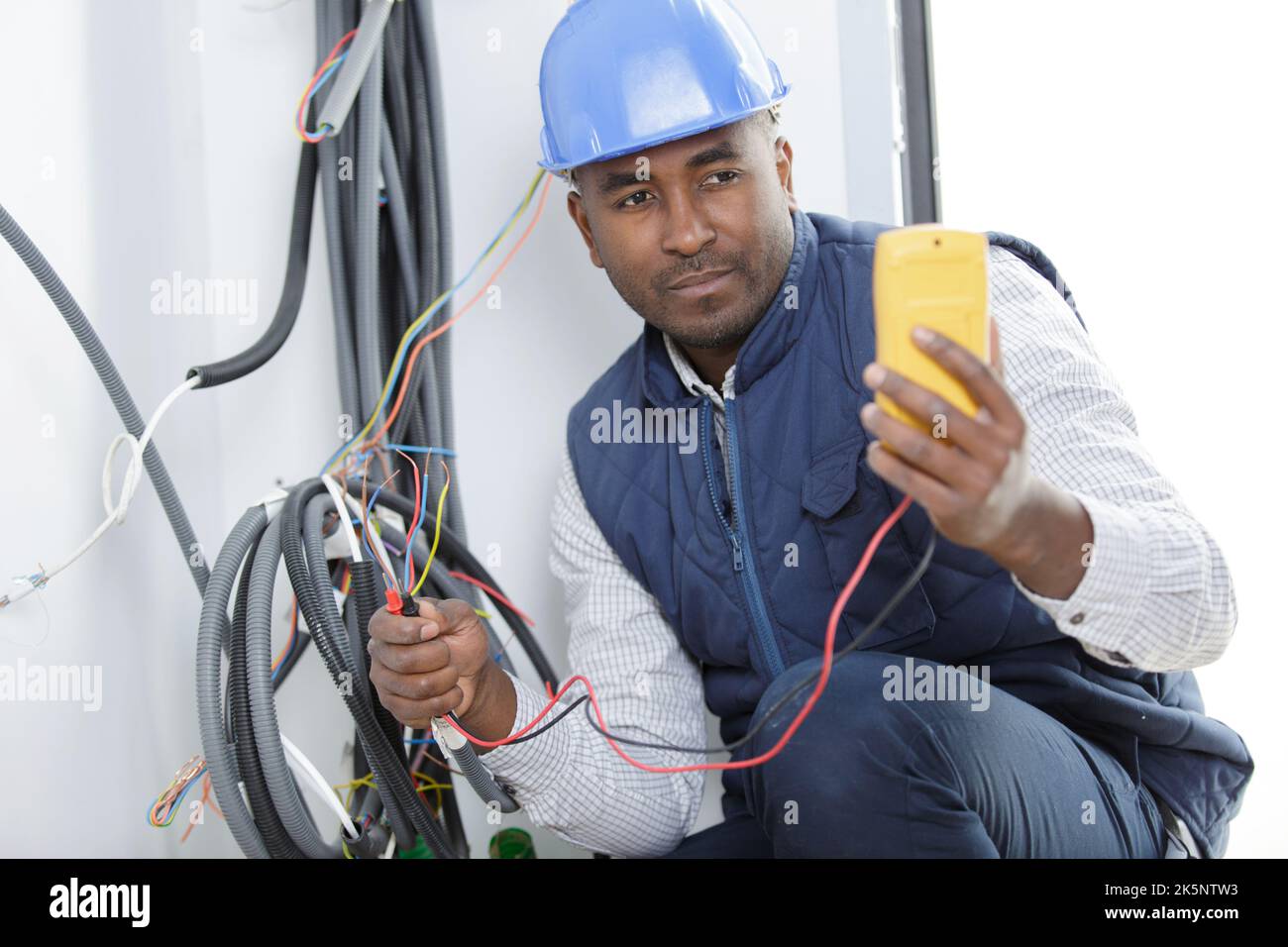 male electrician checking wiring with a multimeter Stock Photo - Alamy
