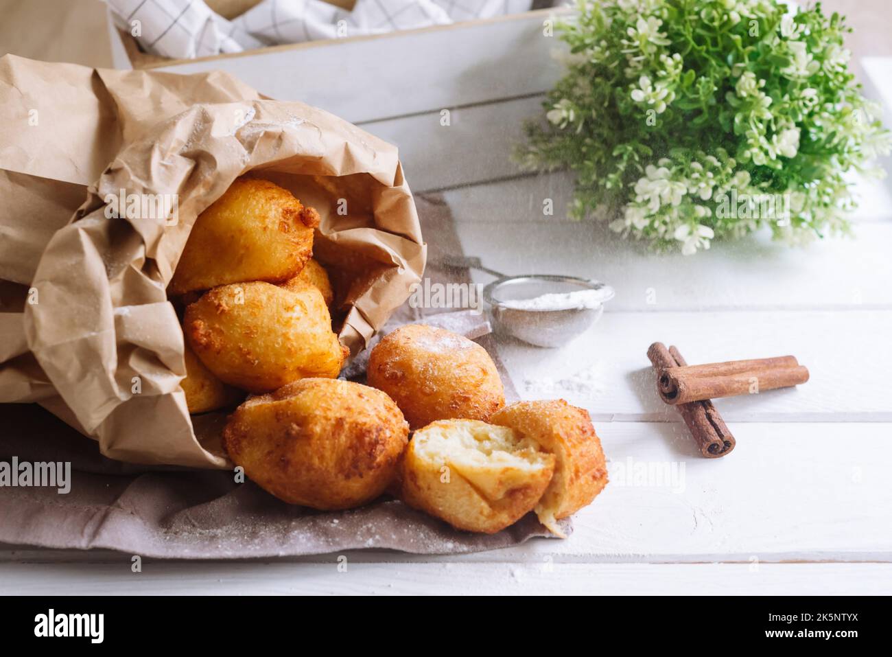 Cottage cheese round doughnuts pile with powdered sugar in a paper bag ...