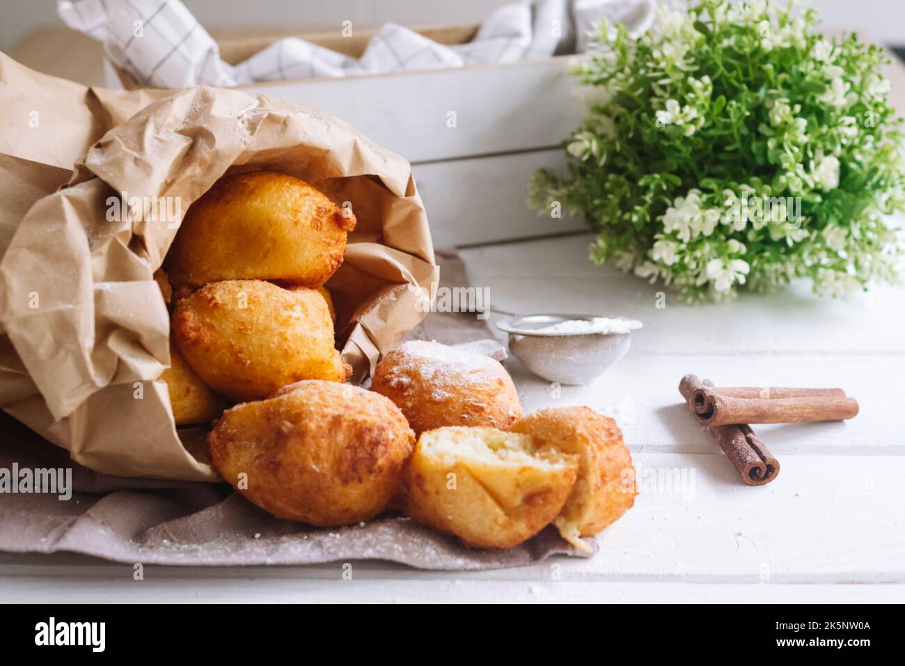 Cottage cheese round doughnuts pile with powdered sugar in a paper bag ...