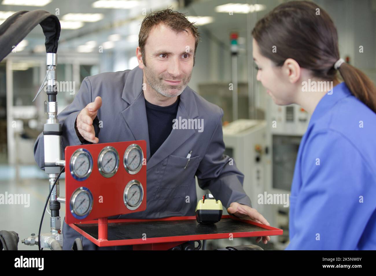 apprentice checking pressure with teacher Stock Photo - Alamy