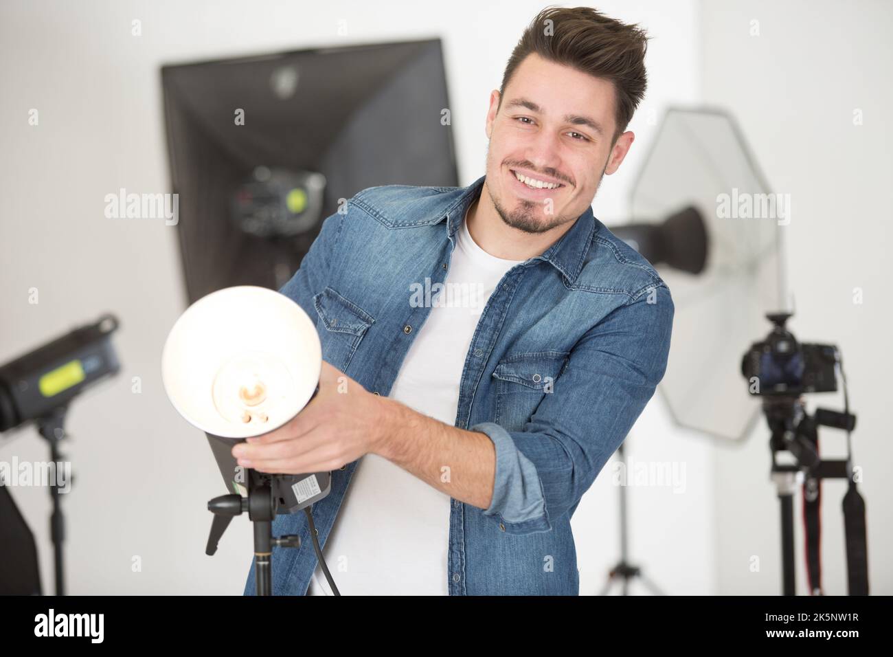 male photographer preparing his studio Stock Photo - Alamy