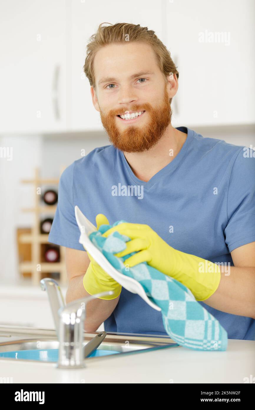 a happy man washing dishes Stock Photo - Alamy