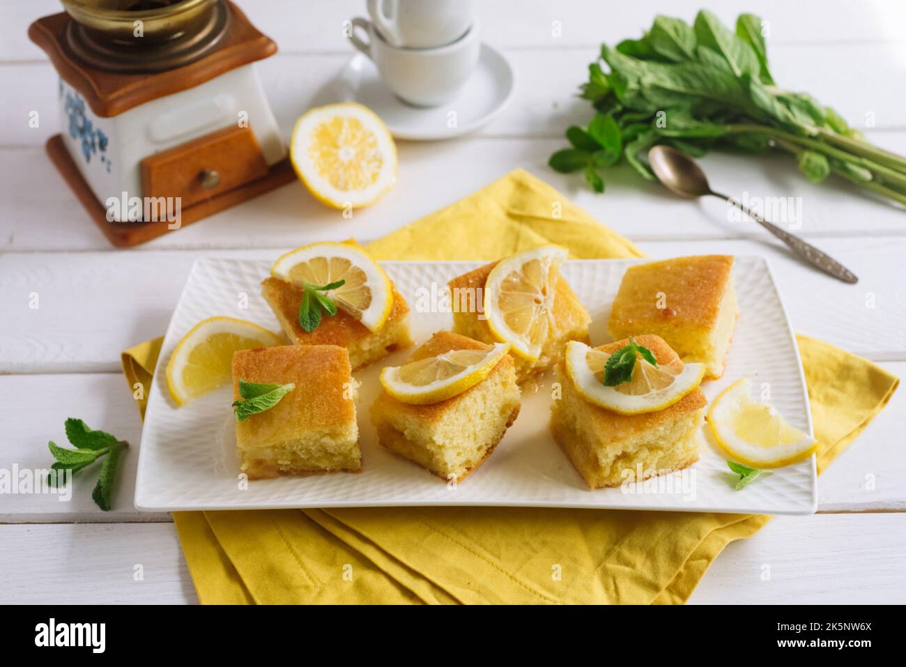 Lemon biscuit in square slices, garnished with fresh lemon slices and ...