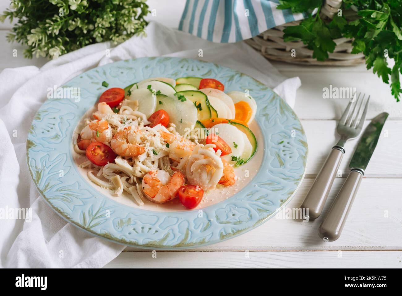 Seafood with vegetables and daikon. A plate of healthy food. Fried ...