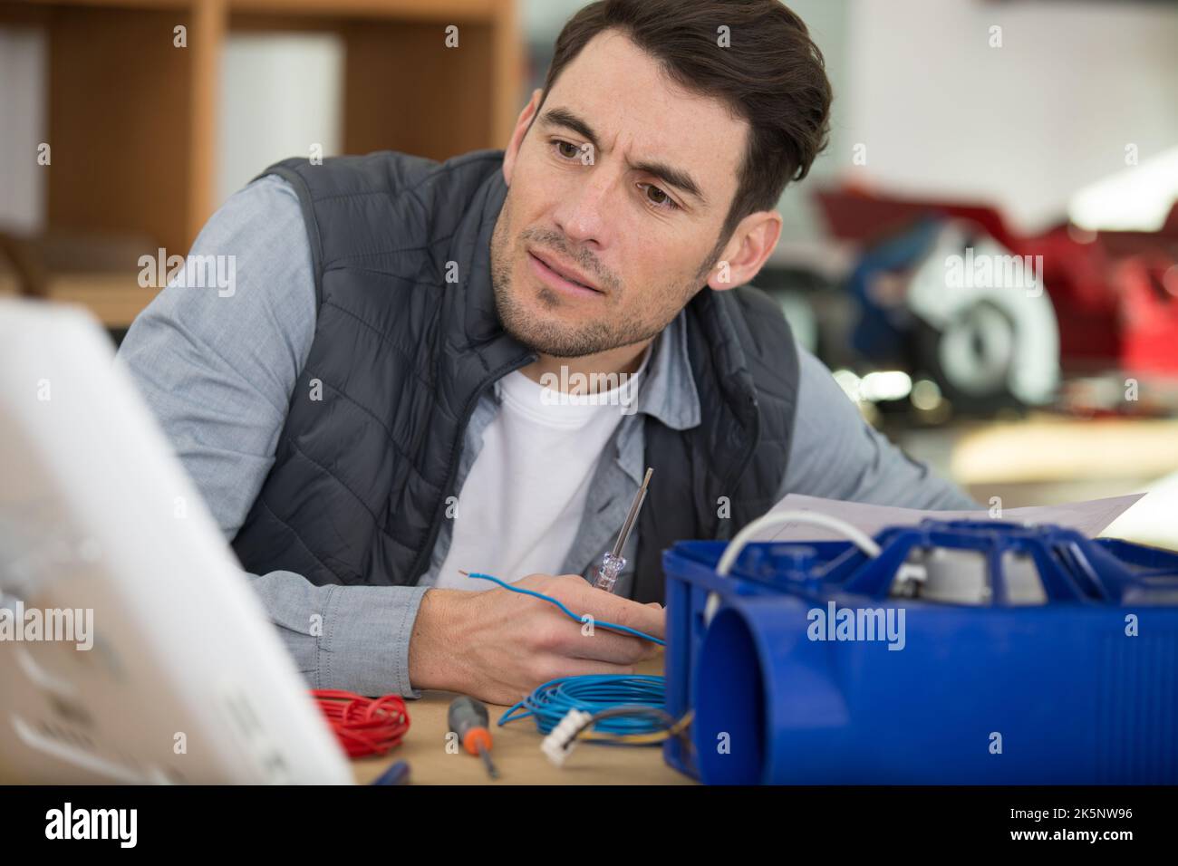 male electrician connecting wires on an electrical appliance Stock ...