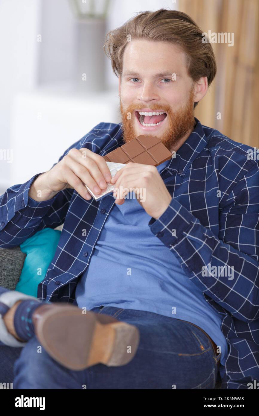 Man eating a chocolate bar hi-res stock photography and images - Alamy