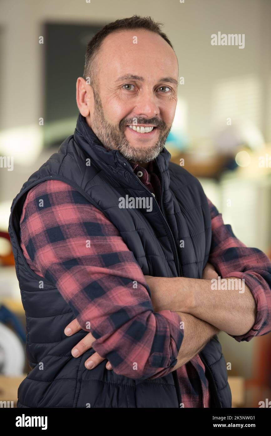 carpenter standing with his armscrossed in his woodworking-studio Stock ...