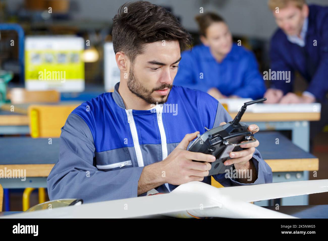 young engineer at desk with remote control aircraft Stock Photo - Alamy