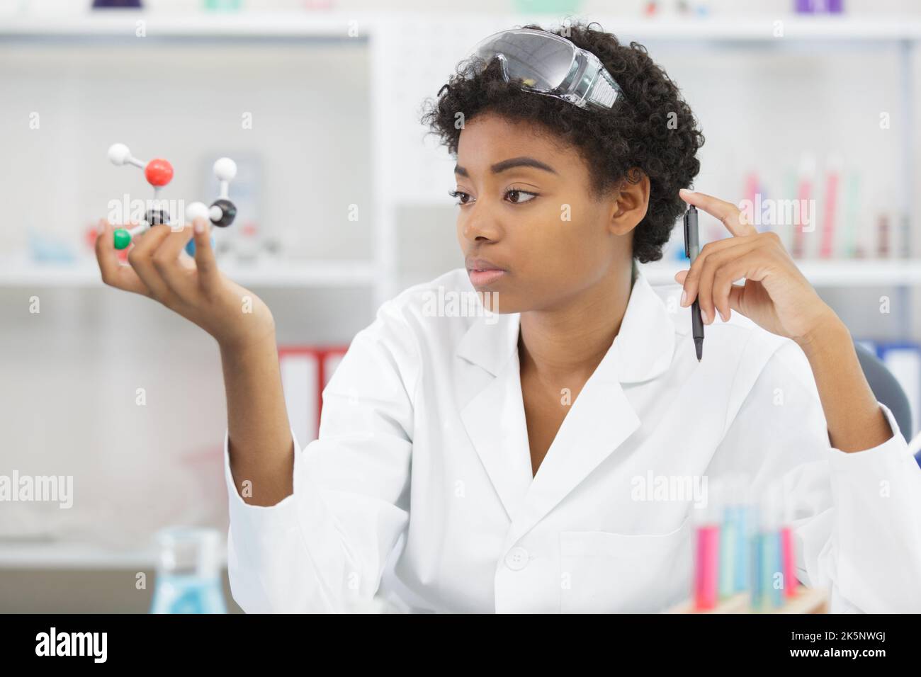 beautiful female scientist holding molecule model Stock Photo - Alamy