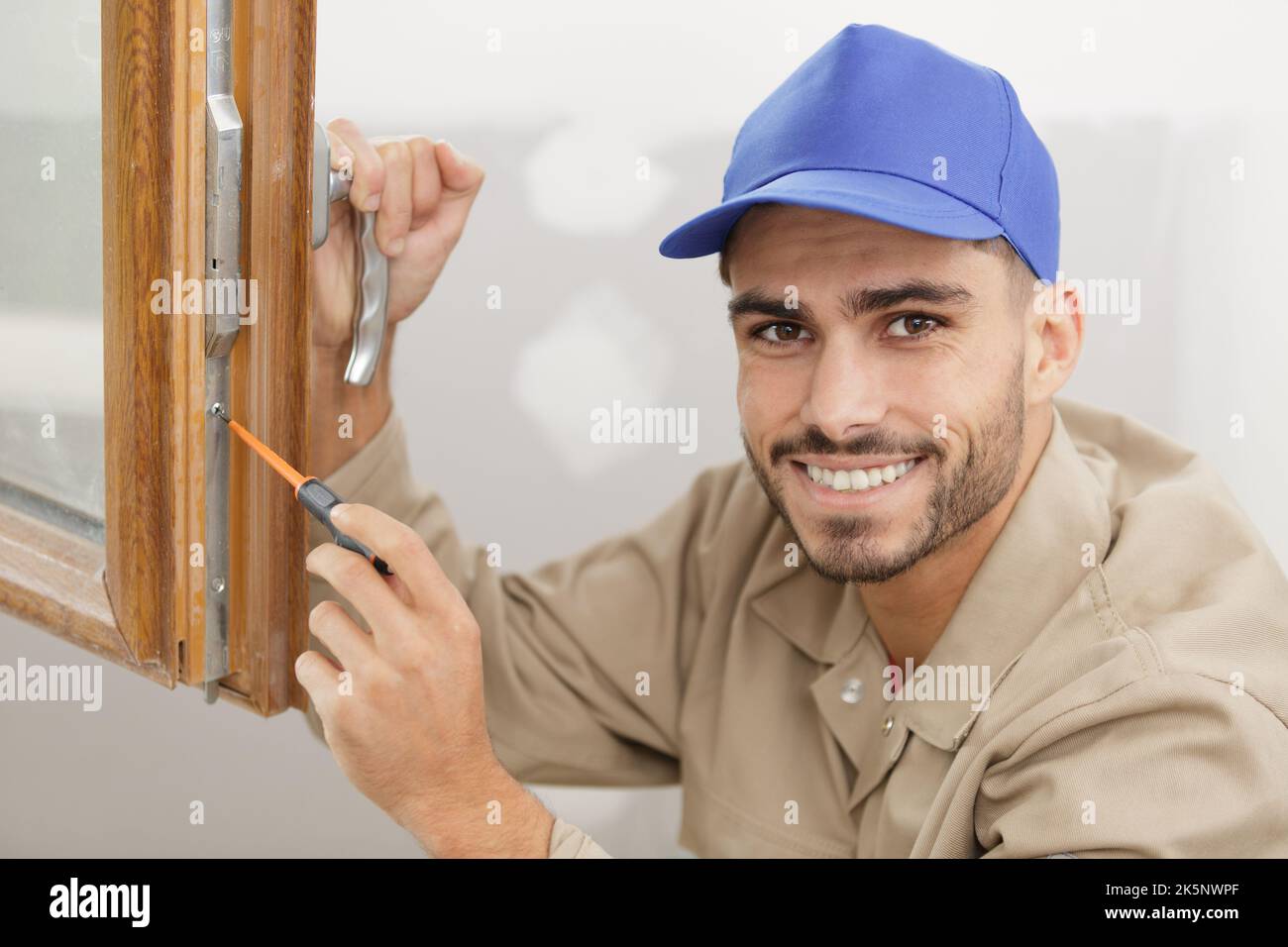portrait of male window fitter using screwdriver Stock Photo - Alamy