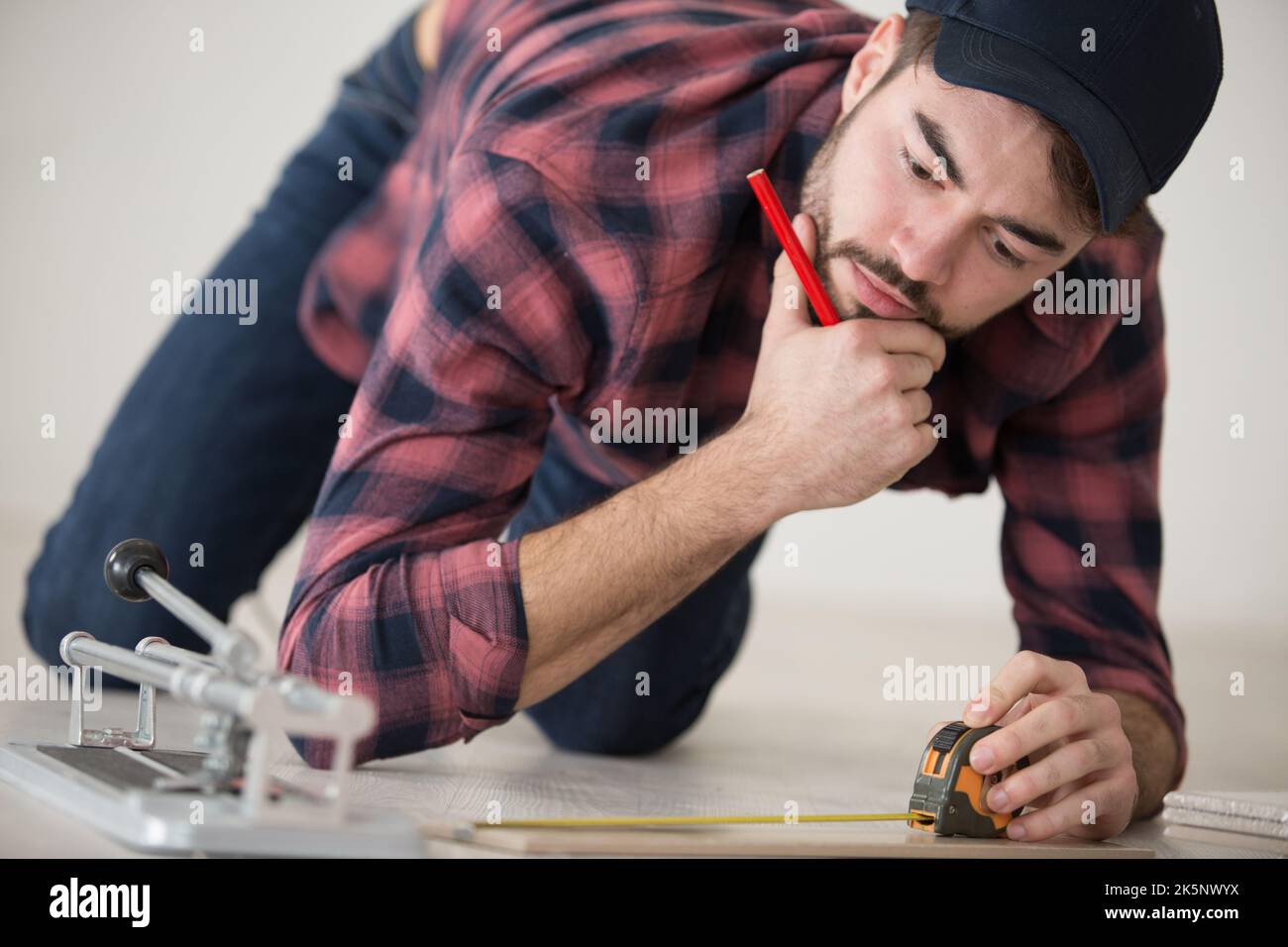 a male handyman making measurements Stock Photo - Alamy