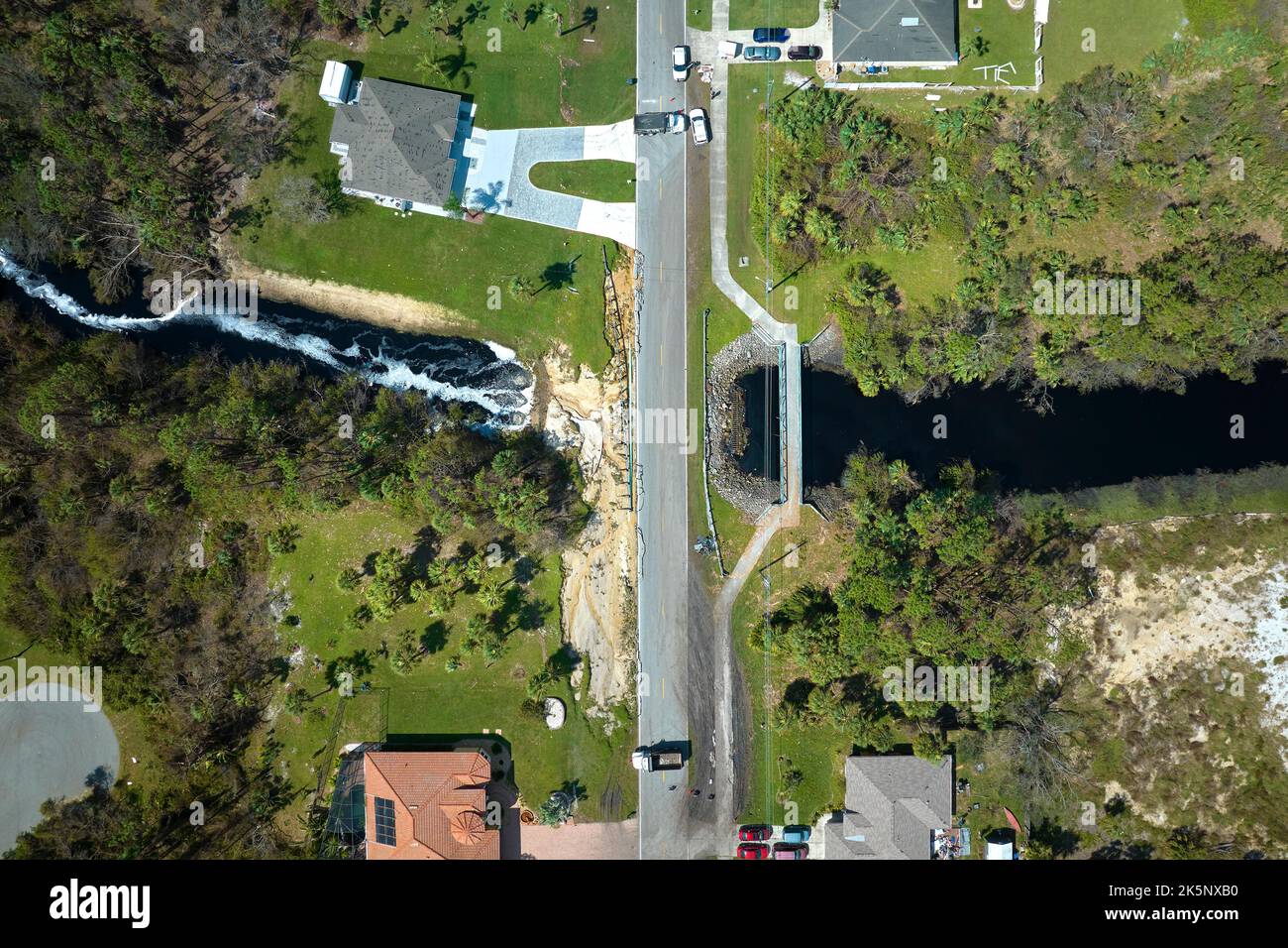Aerial view of damaged road bridge over river after flood water washed ...