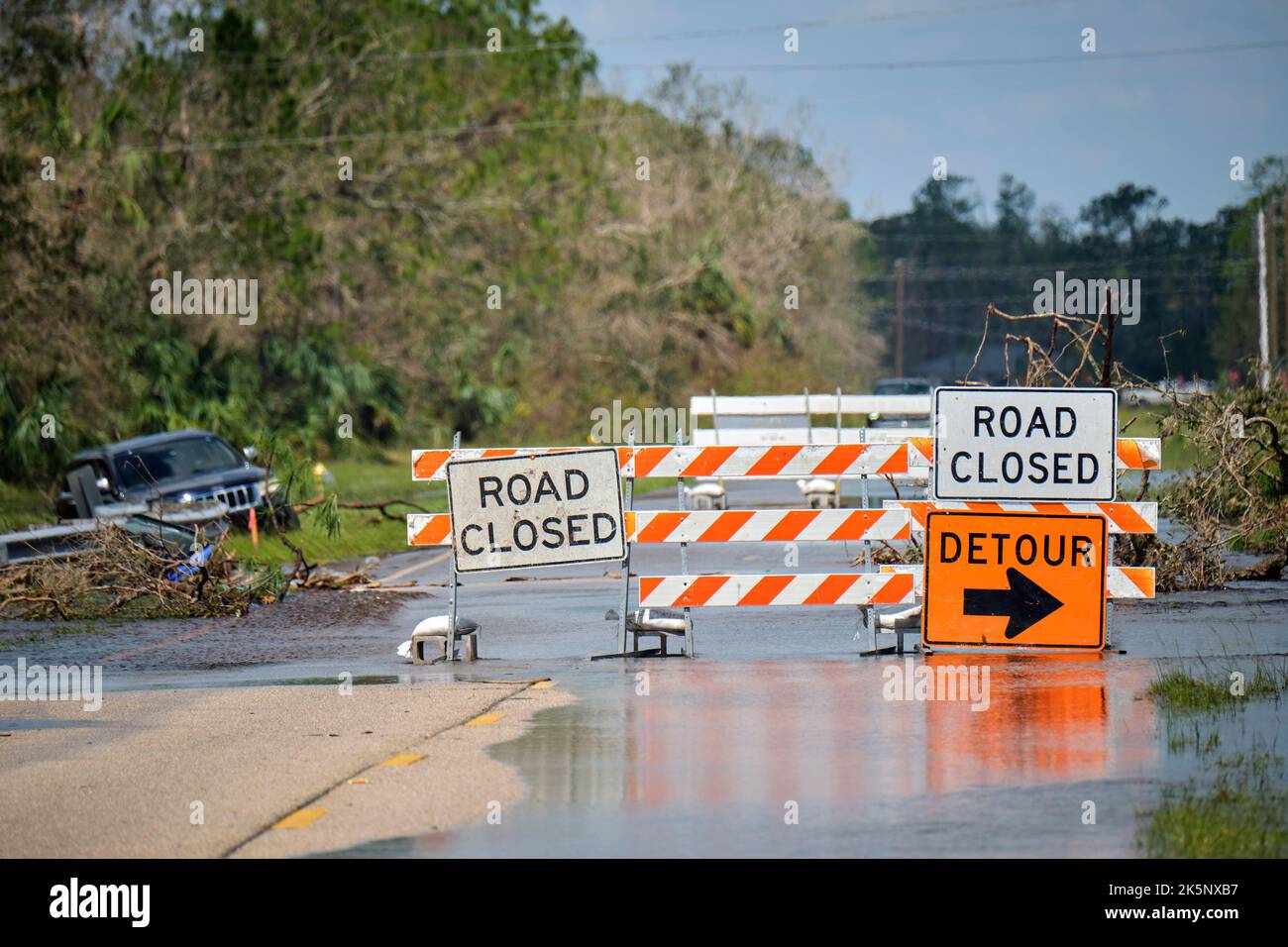 Hurricane Ian flooded street with road closed signs blocking driving of ...