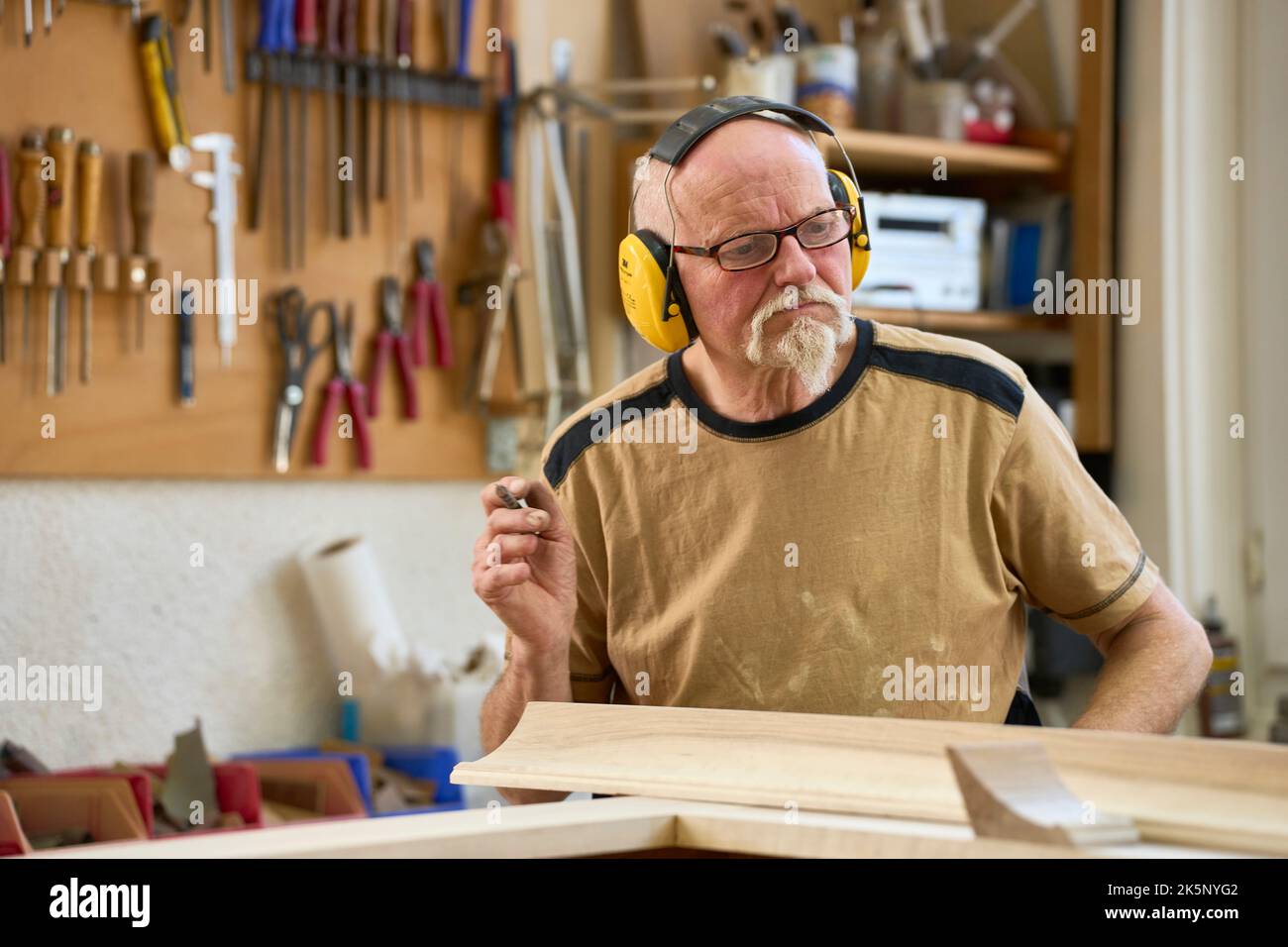 Antique Carpenter Checks A Dimension With A Skeptical Eye Before Sawing ...