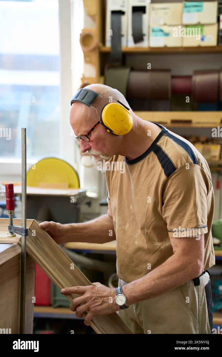 Antique Carpenter Attaches A Skirting Board To A Baroque Cabinet In His ...