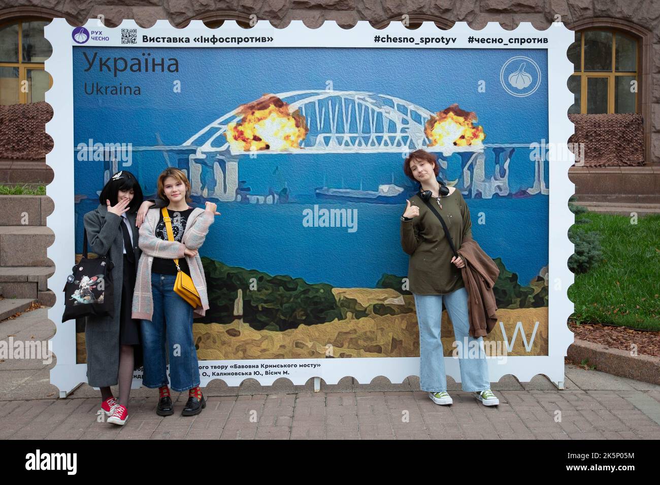 Kyiv, Ukraine. 9th Oct, 2022. People pose for a photo with a stamp ...
