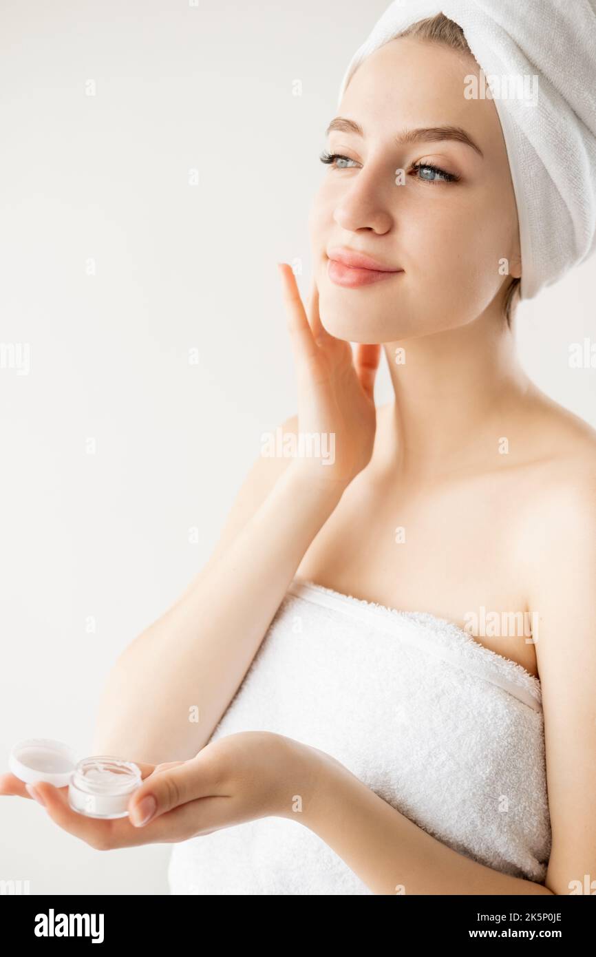 Skincare cosmetic. Beautiful woman. Facial treatment. Nourishing moisturizing. Pretty smiling ...