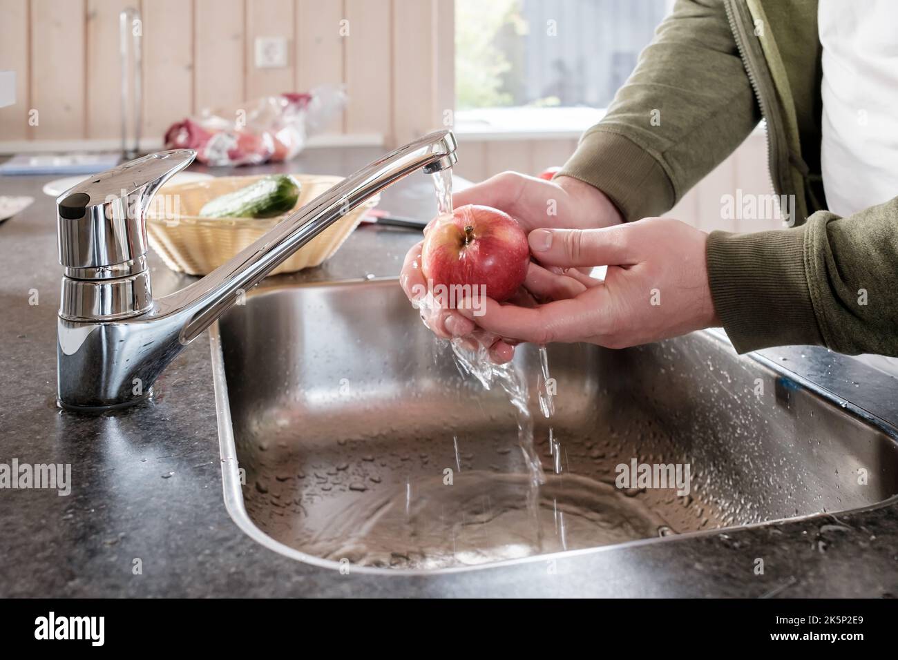 Washing fresh cucumber under running hi-res stock photography and ...