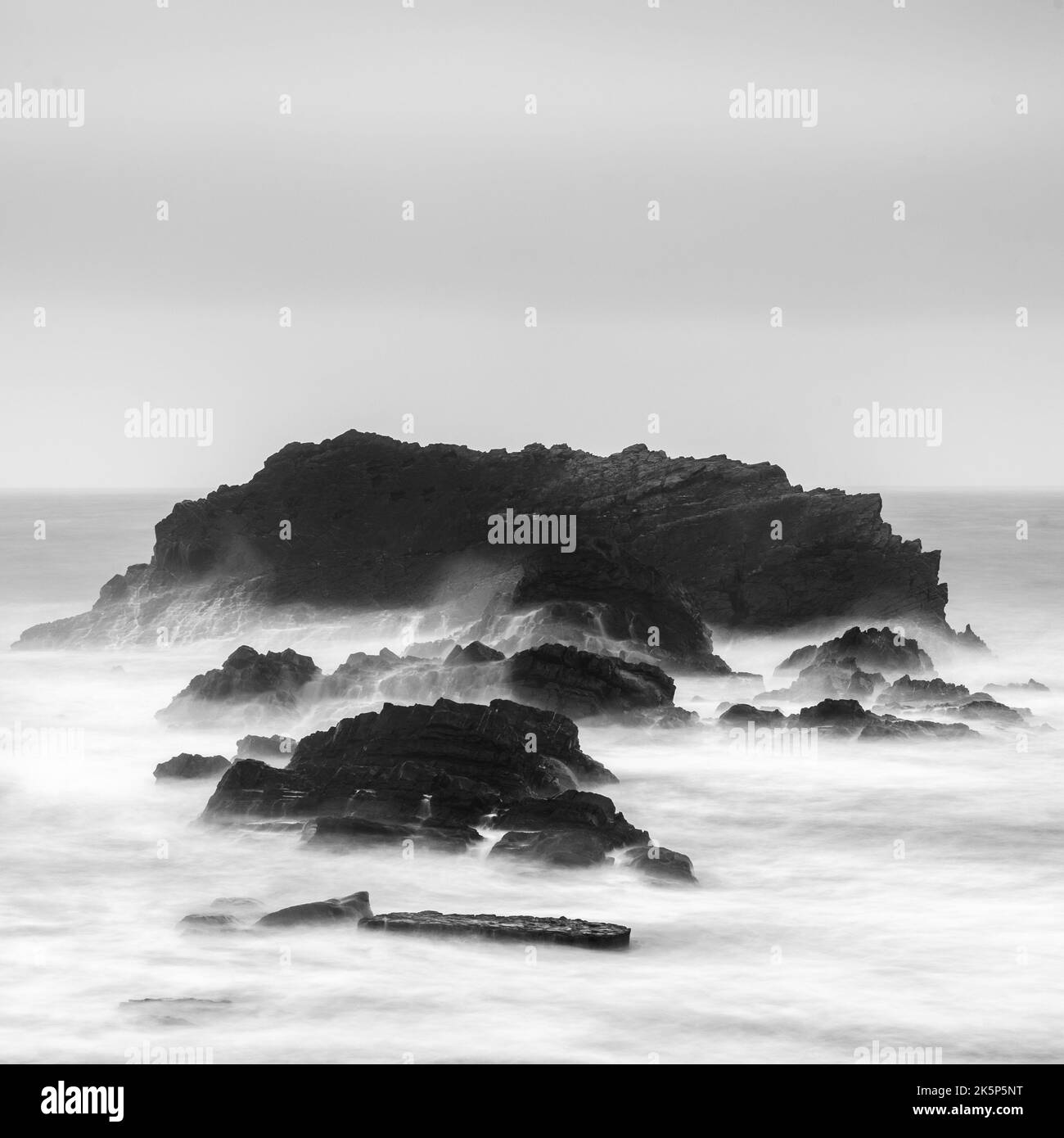 A mesmerizing scenery of a seascape during the sunset in grayscale ...