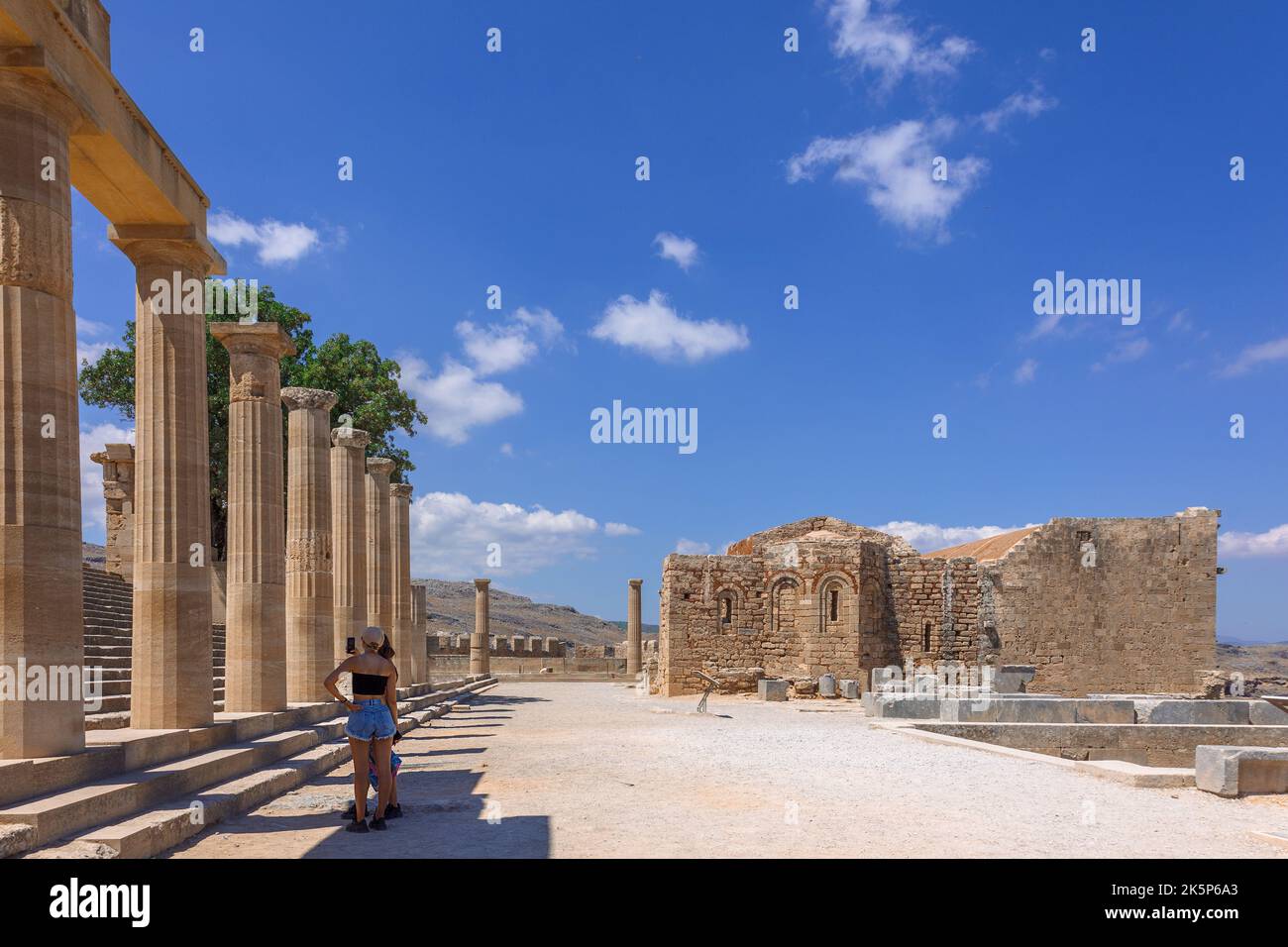 Panoramic view of ruins of ancient city of Lindos on colorful island of ...