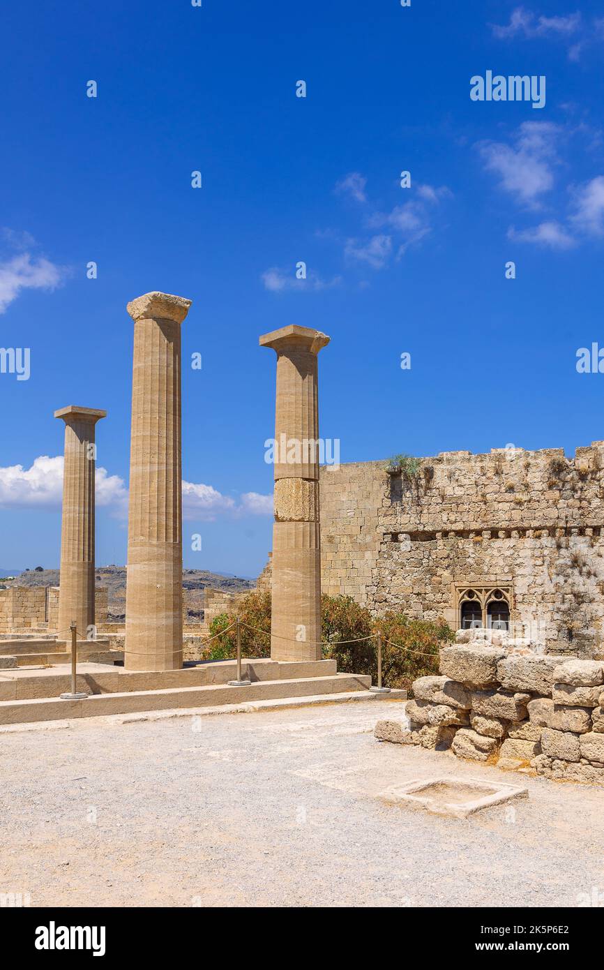 Panoramic view of ruins of ancient city of Lindos on colorful island of ...