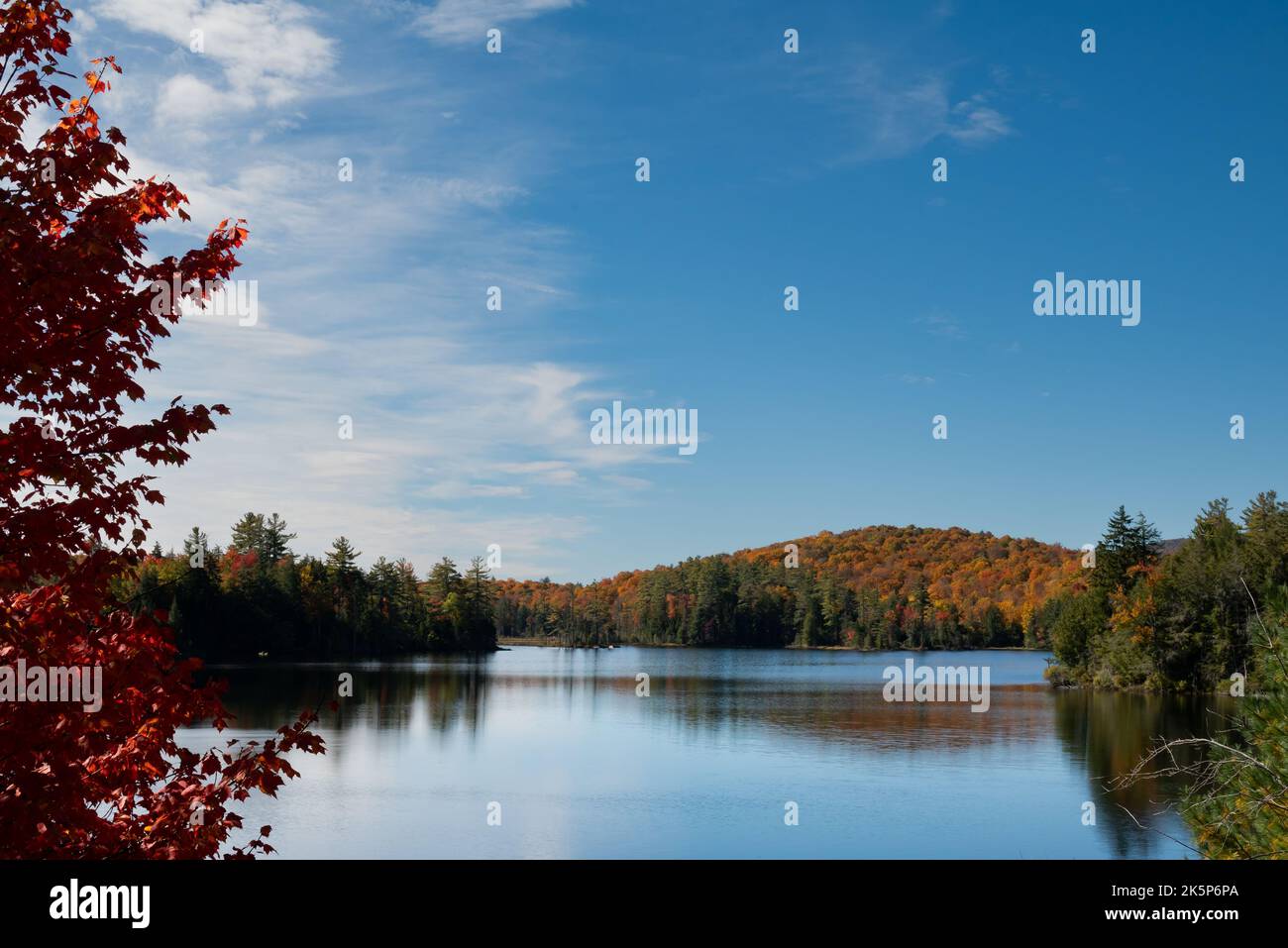 An autumn view of Mason Lake in the Adirondack Mountains, NY USA with ...