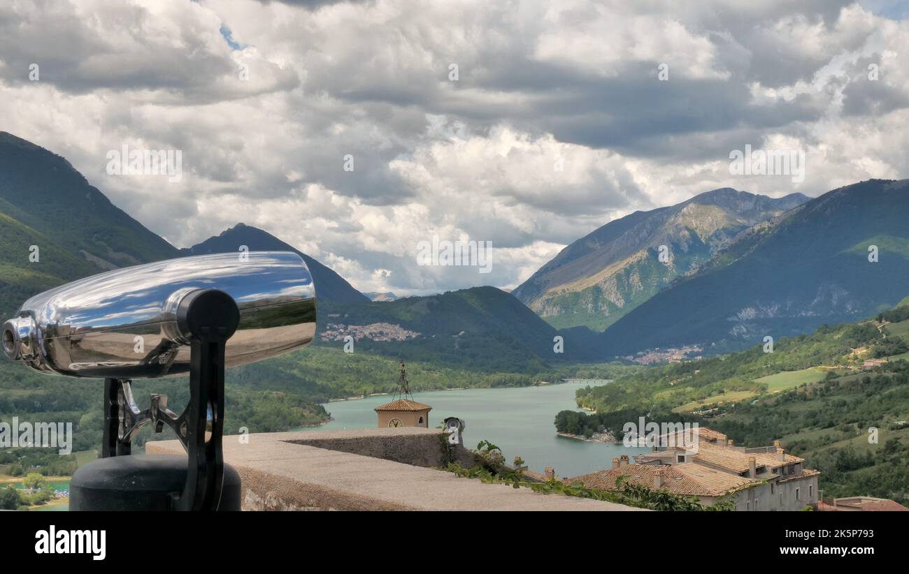 tourist telescope look at the city with a view of the mountains, close ...