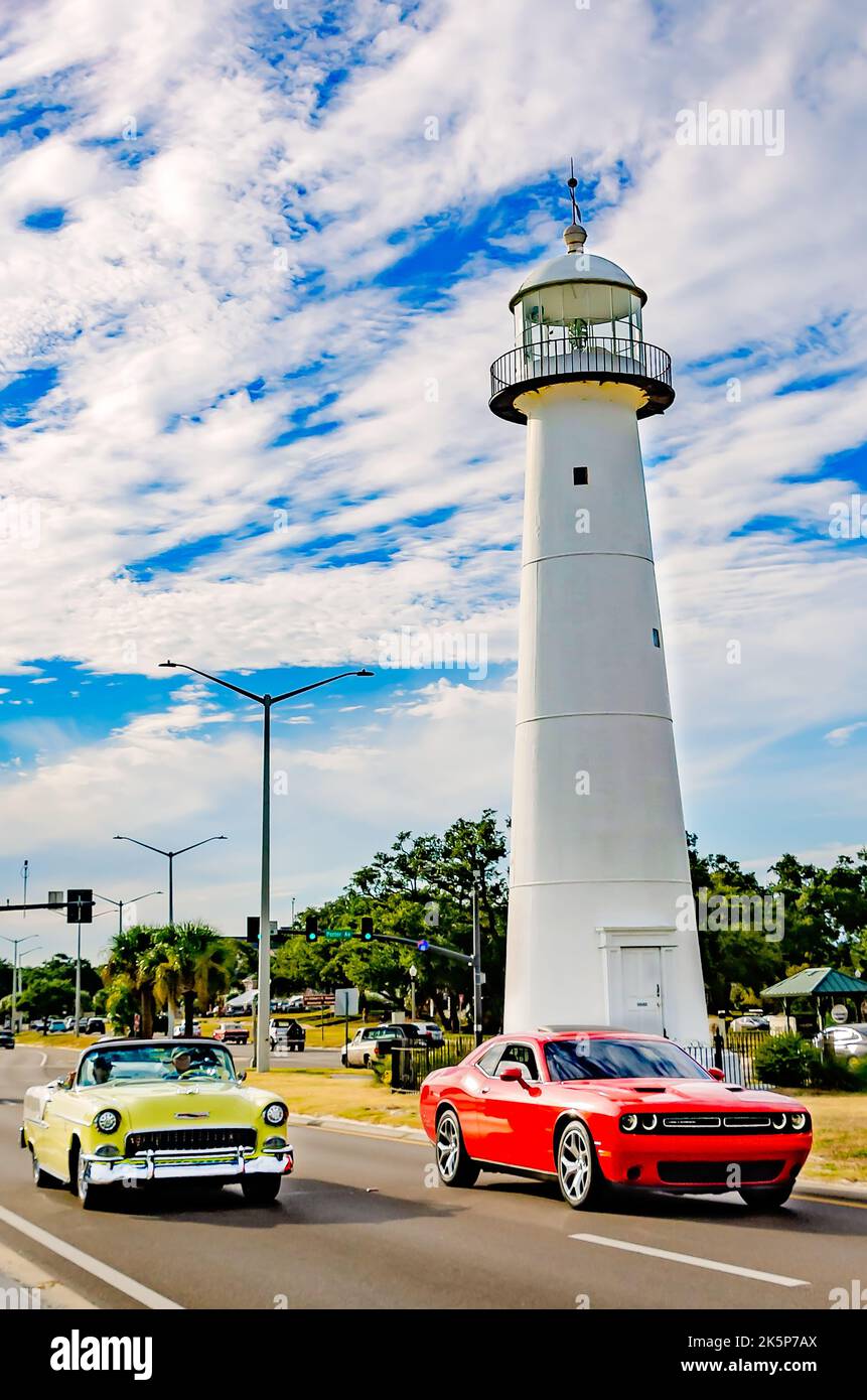 Vintage automobiles pass the Biloxi lighthouse during the 26th annual ...