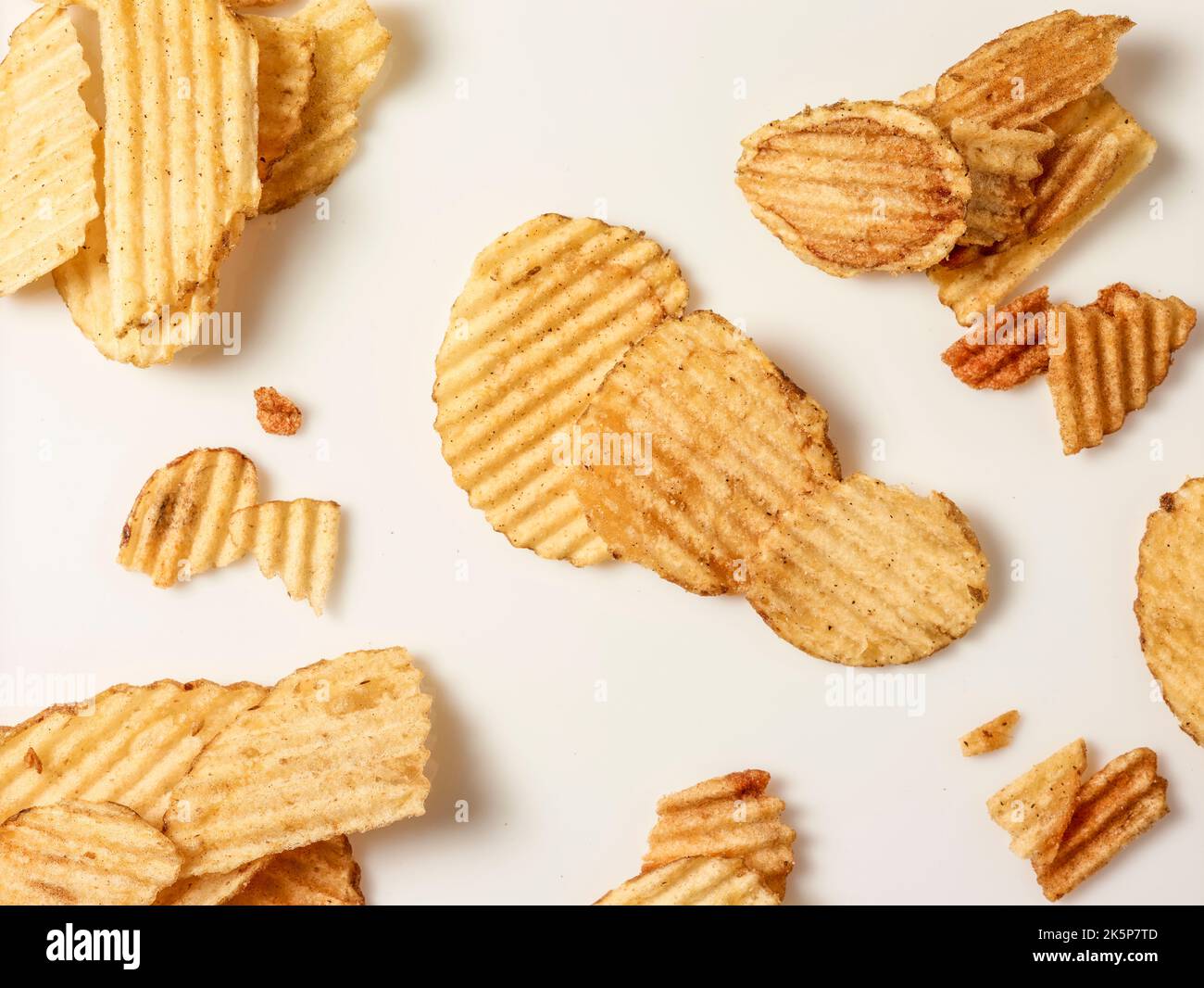 Food snack still-life of Crinkle cut crisps on plain background Stock ...