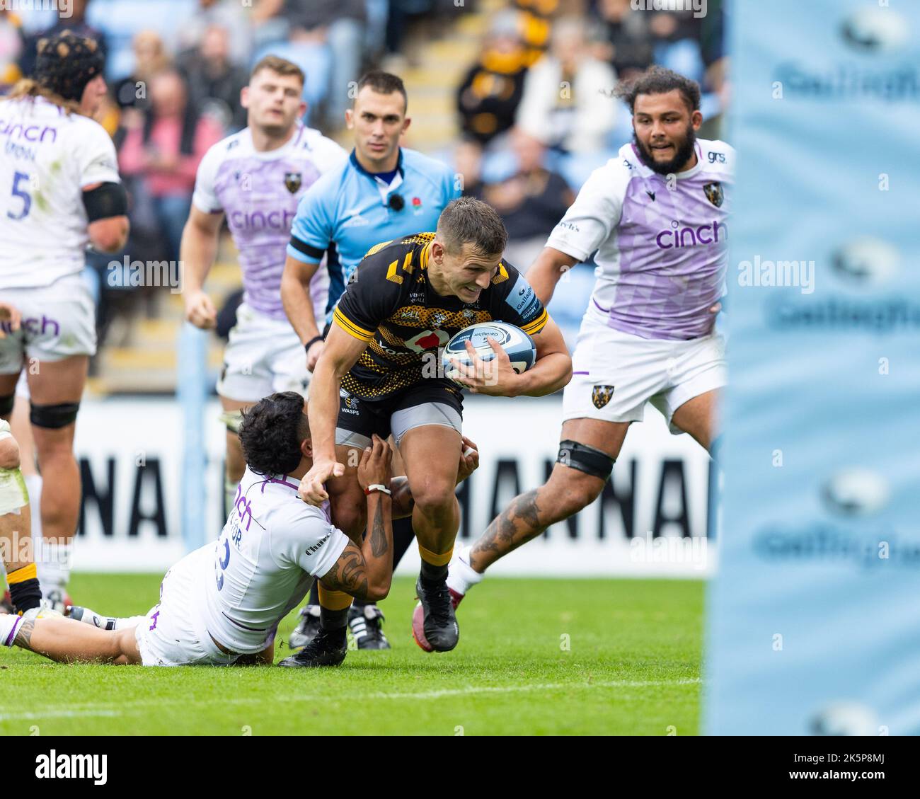 Ryan Mills of Wasps Rugby is tackled by Matt Proctor of Northampton ...