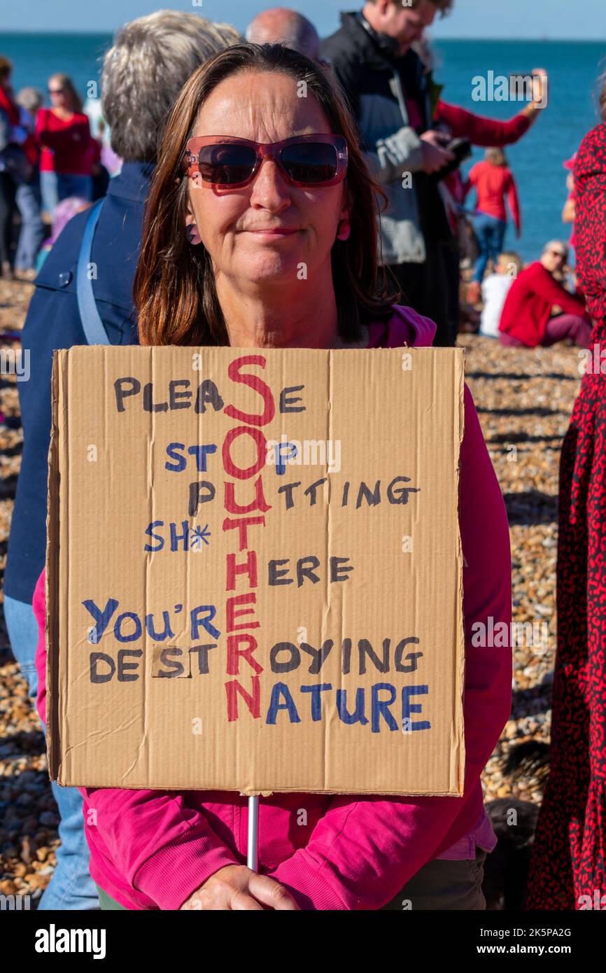 Various placards and a flag held by protesters at Tankerton Beach, nr ...