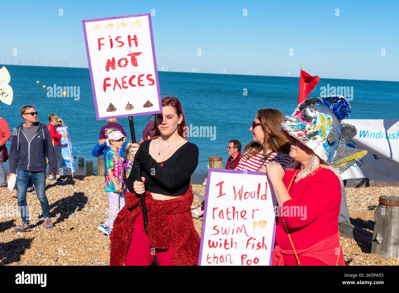 Various placards and a flag held by protesters at Tankerton Beach, nr ...