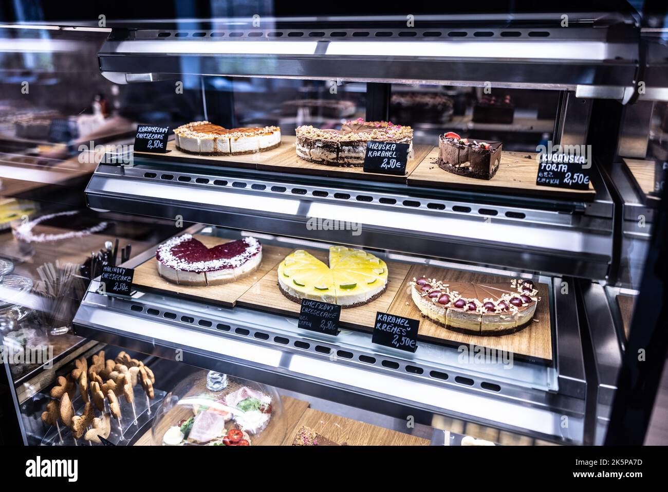 Confectionery showcase of broad variety of sweets and desserts behind ...