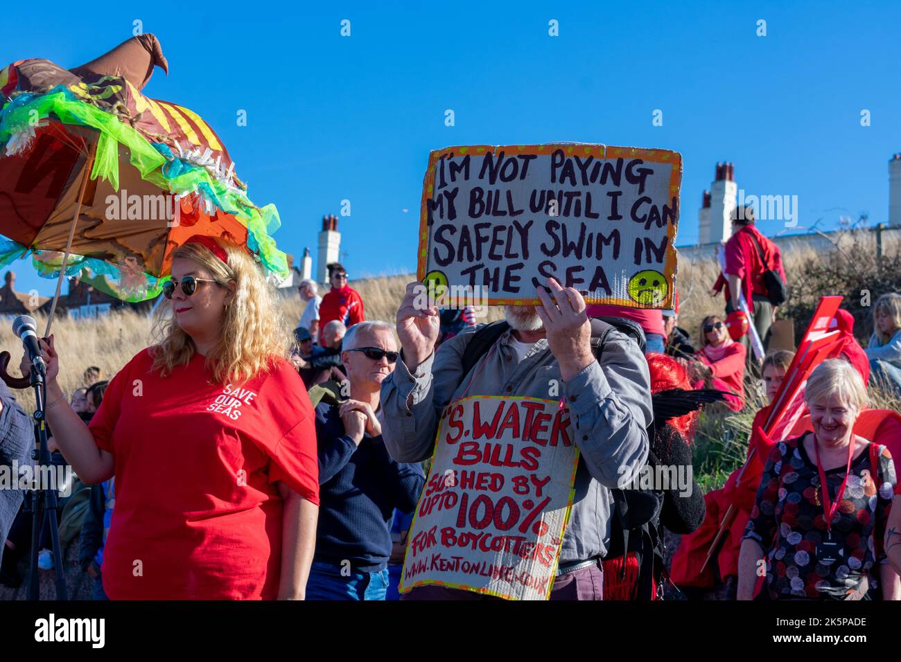 Various placards and a flag held by protesters at Tankerton Beach, nr ...
