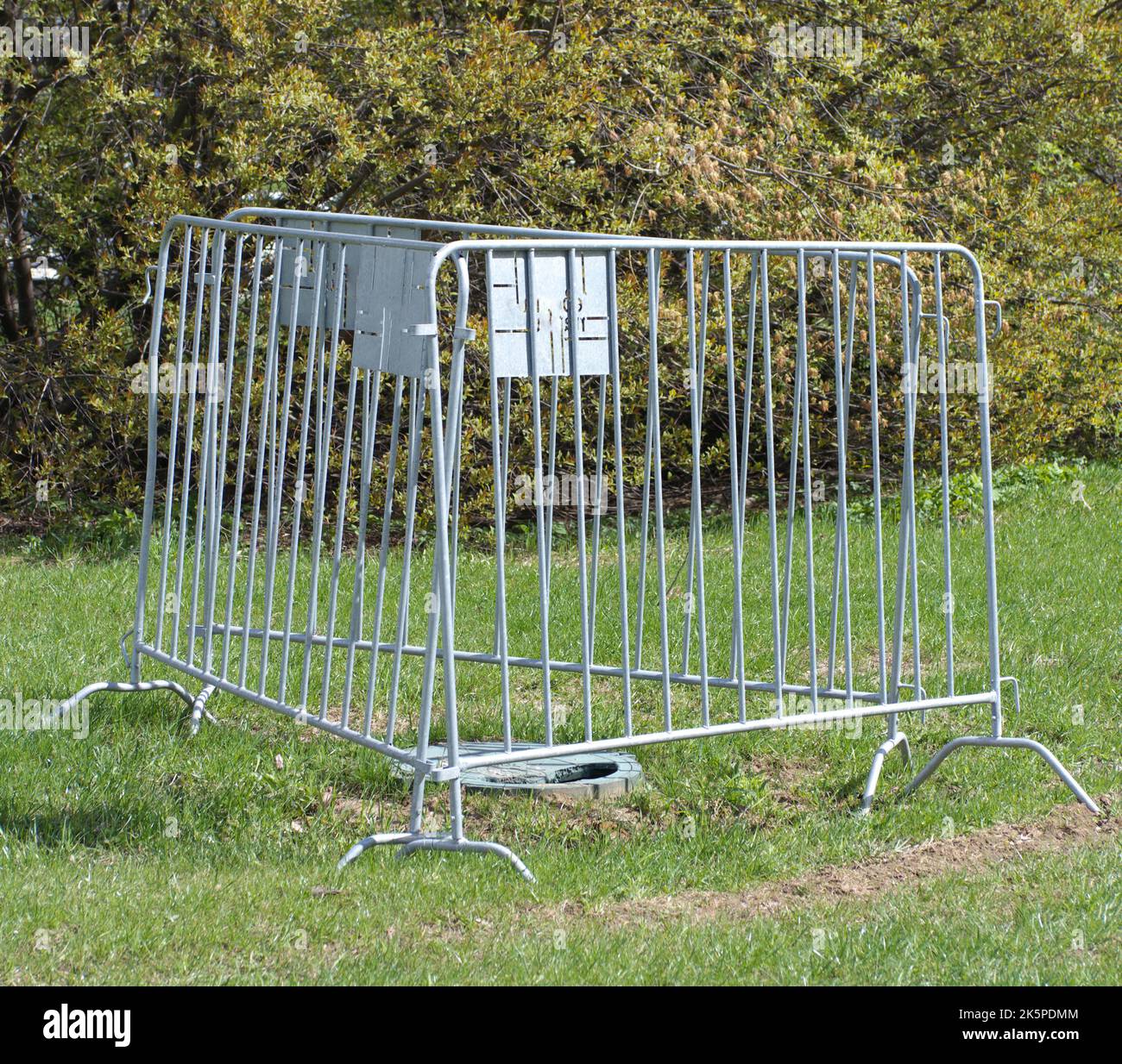 fence around manhole in park at dry sunny summer day Stock Photo - Alamy
