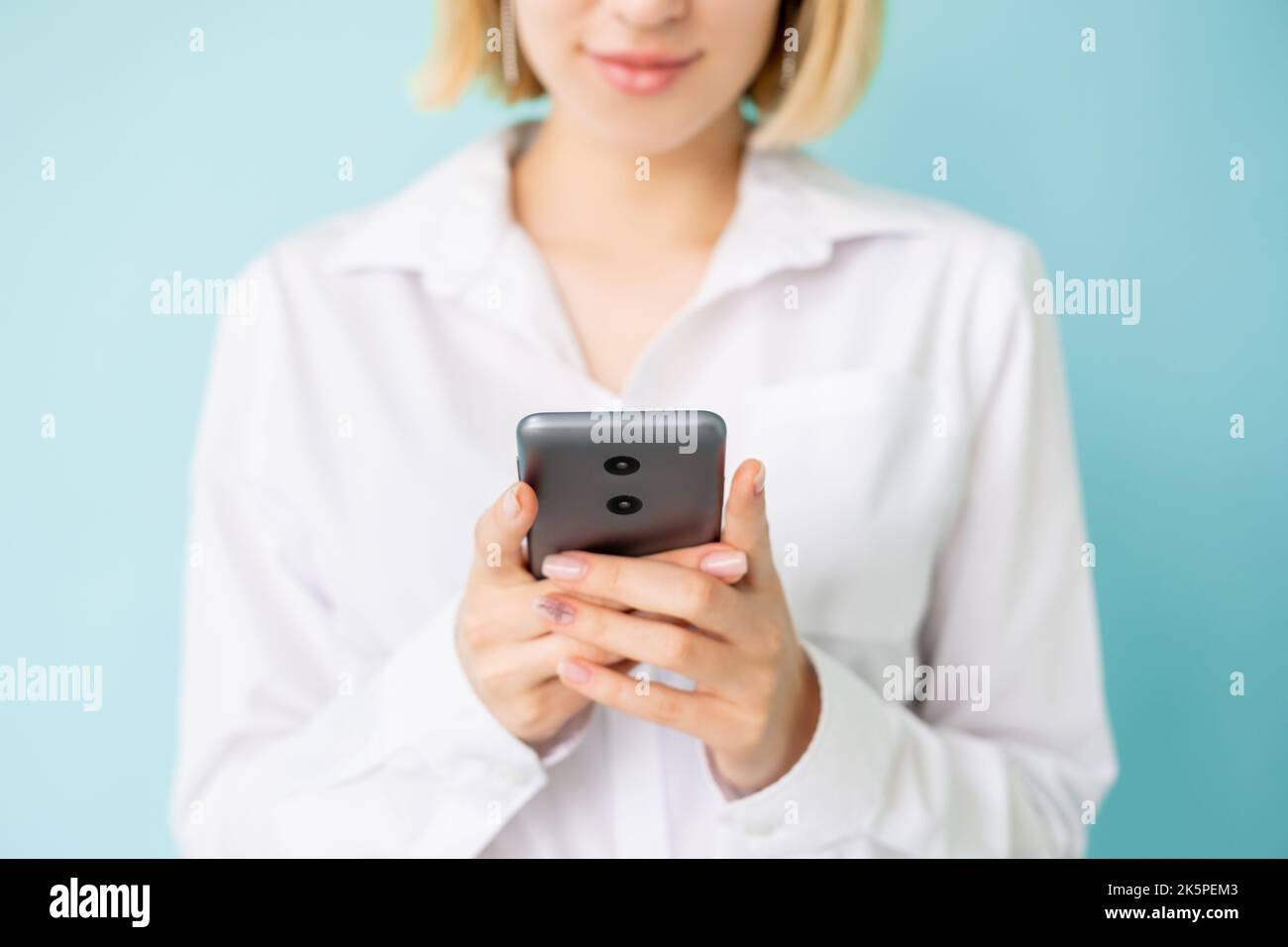 Office chat. Smiling woman. Mobile communication. Unrecognizable pretty ...