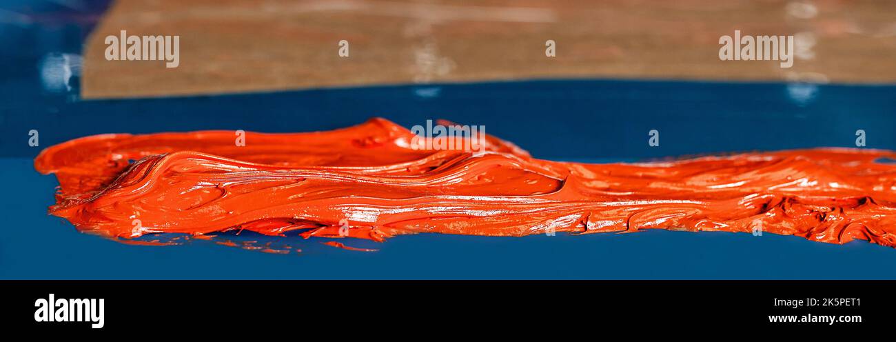 plastisol ink (paint) banner closeup. serigraphy production. printing t ...