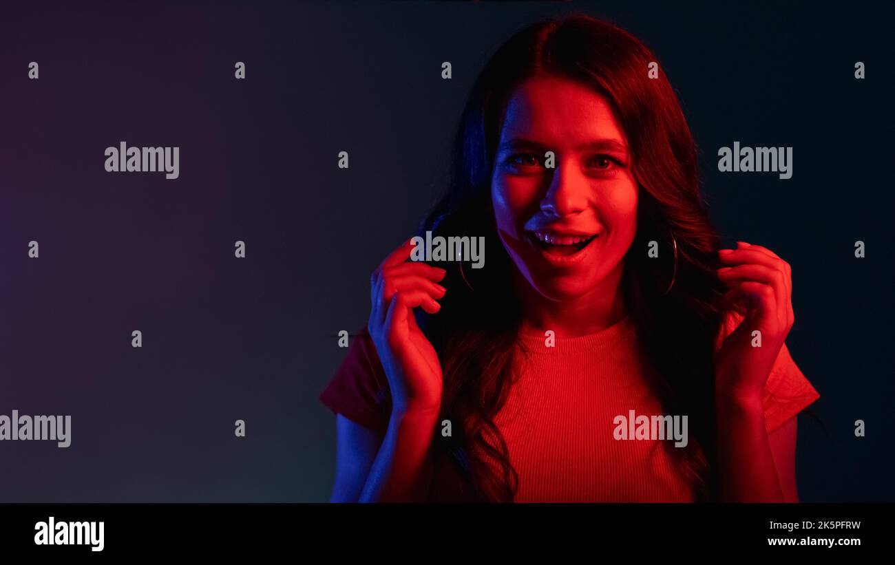amazed woman wow reaction woman red neon light Stock Photo - Alamy