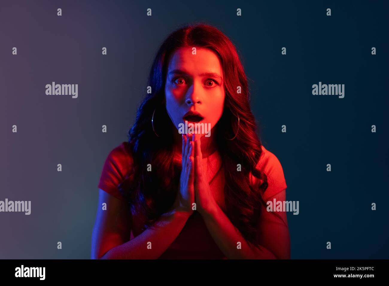 shocked woman color light portrait omg lady red Stock Photo - Alamy