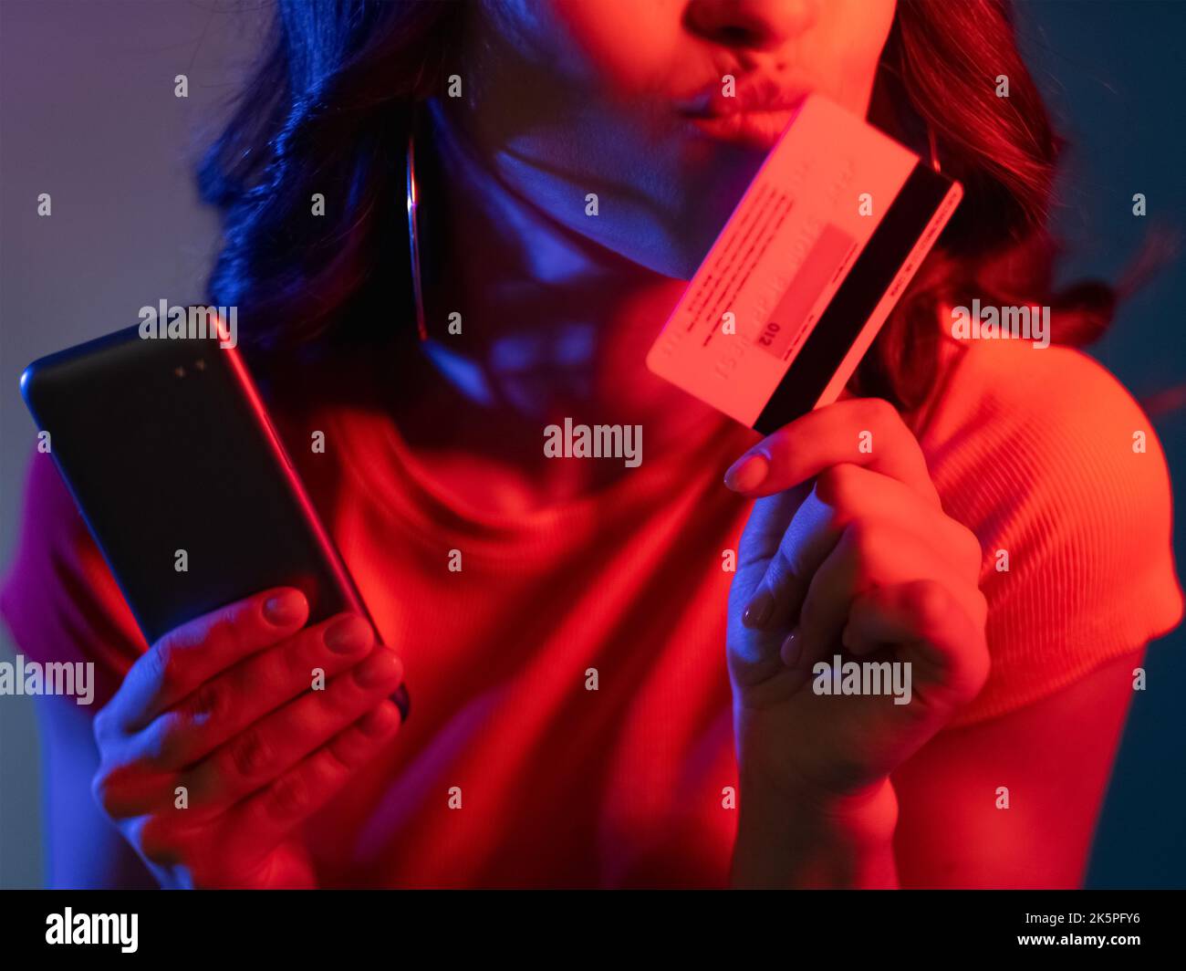 easy payment online purchase woman phone neon card Stock Photo - Alamy